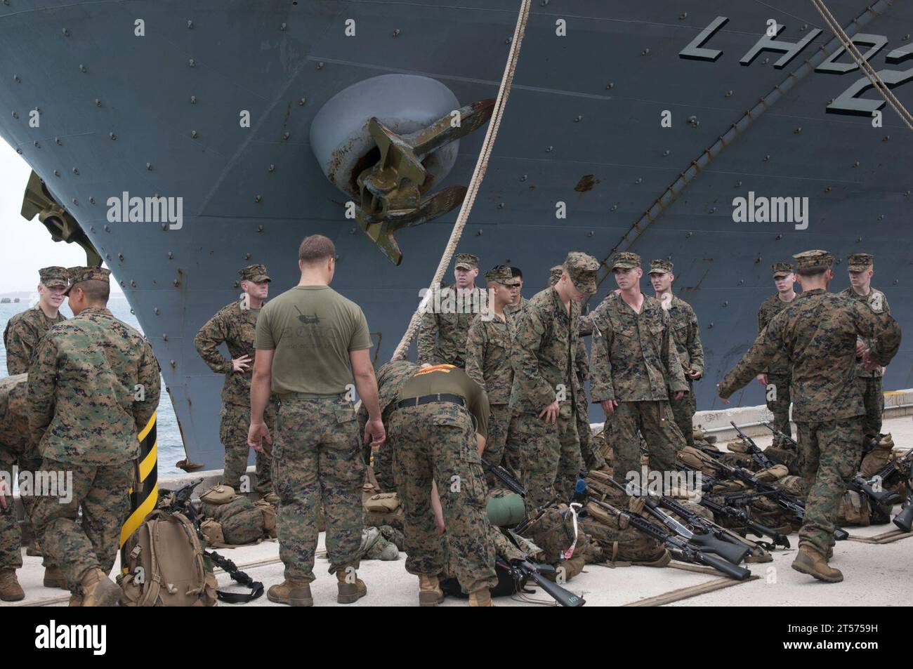 US Navy Marines inventory equipment after disembarking from the forward ...