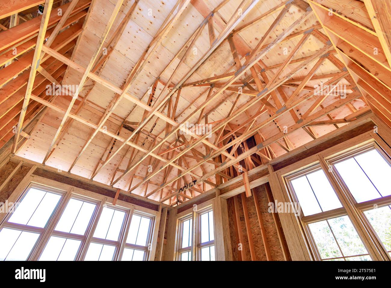 Unfinished framing beams on wooden house in construction site of new ...