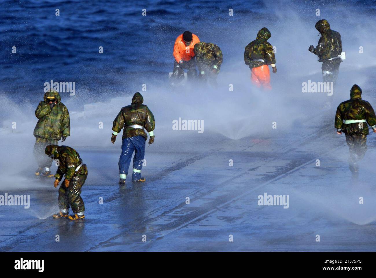 US Navy Members of the crash and salvage team aboard the aircraft ...