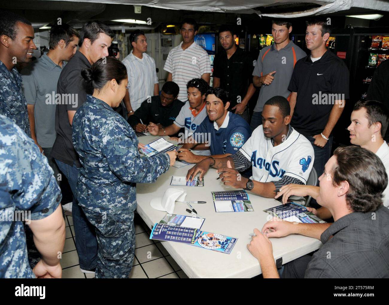US Navy Members of the Everett Aquasox baseball team sign autographs on ...