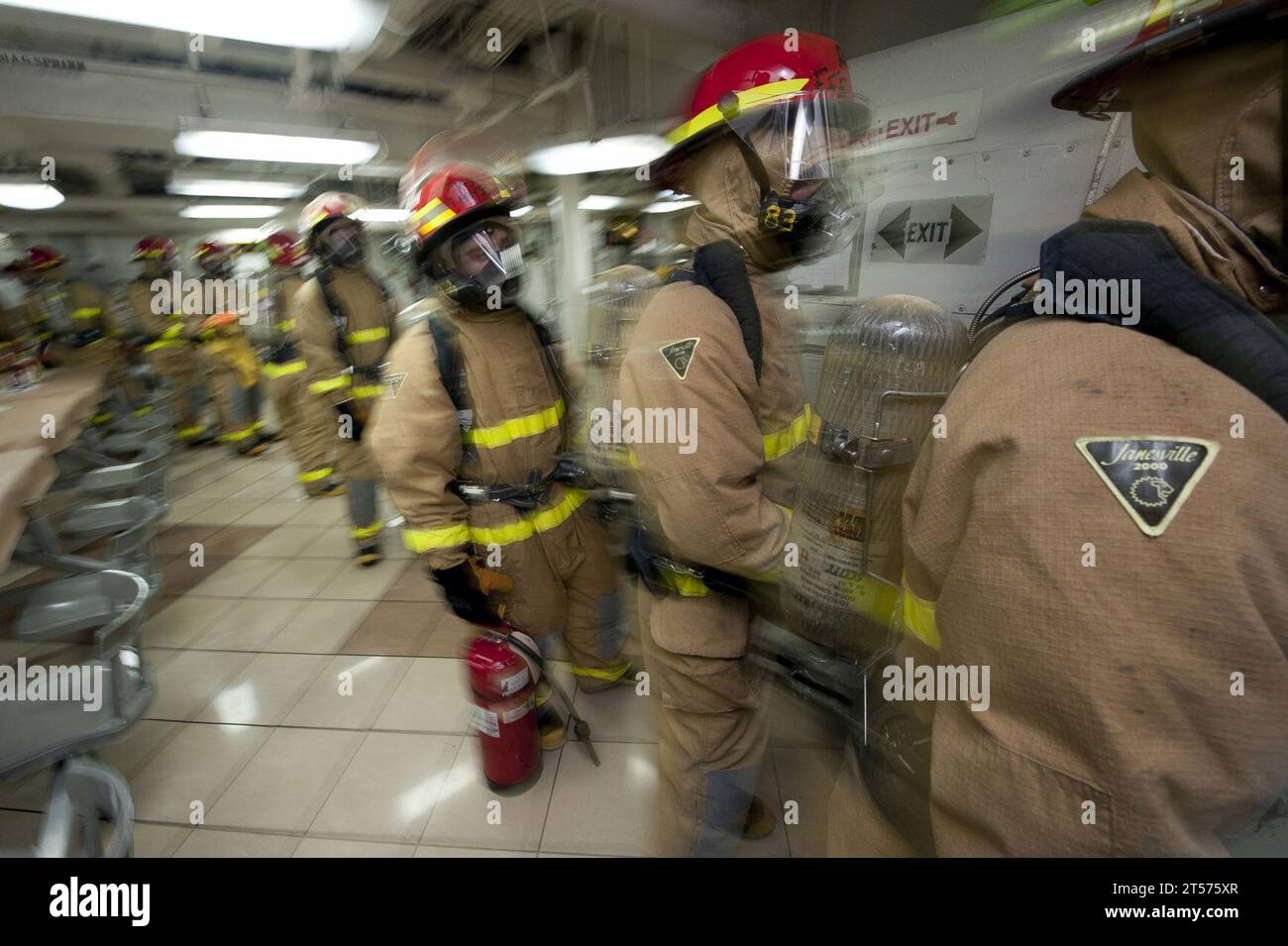 US Navy Members of the ship's flying squad line up on the mess decks as ...