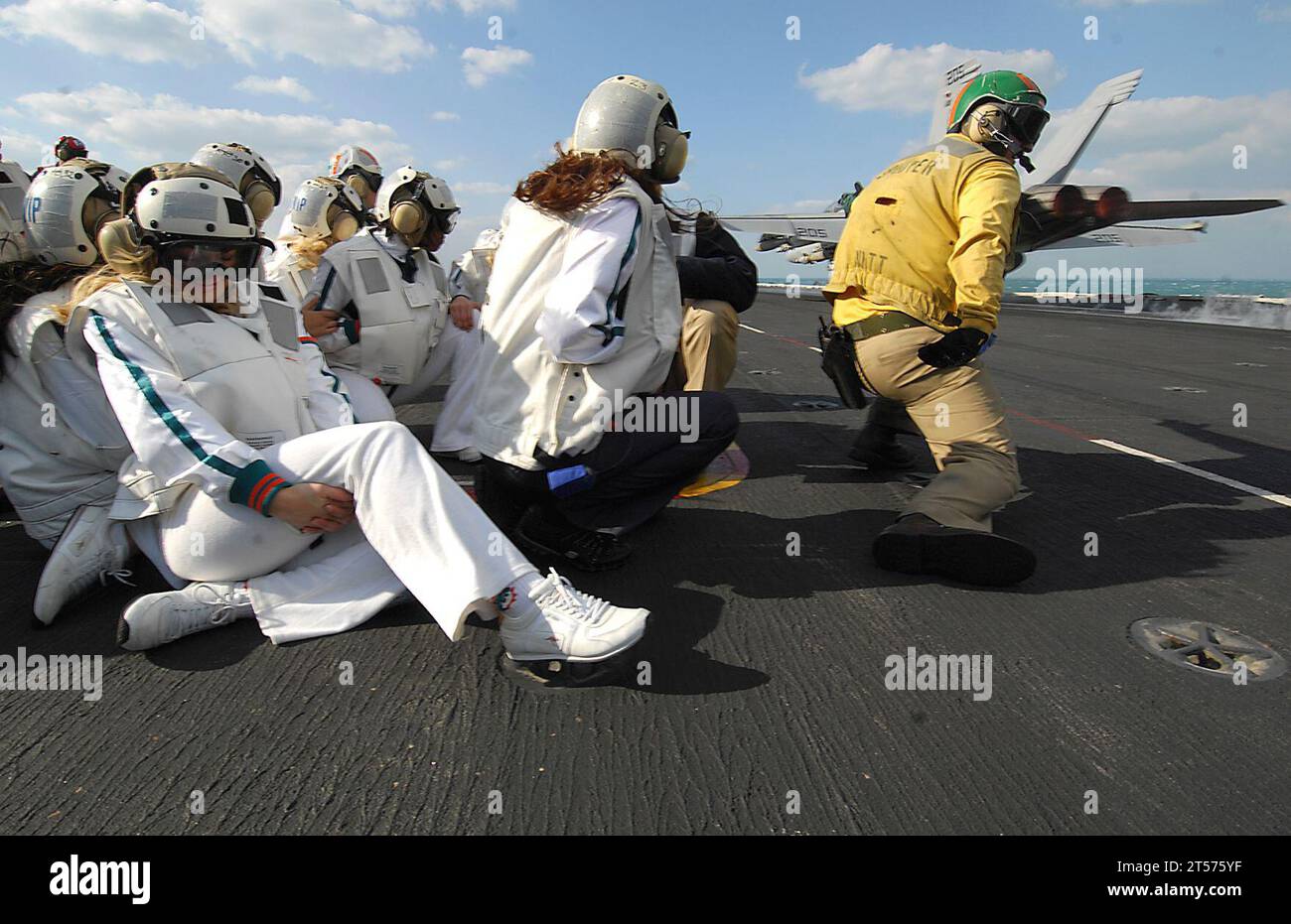 US Navy Miami Dolphins cheerleaders watch an F18 Hornet launch from the ...