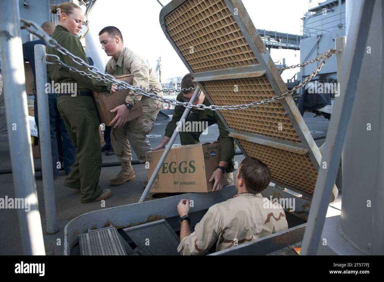 US Navy Sailors aboard the amphibious dock landing ship USS Pearl ...