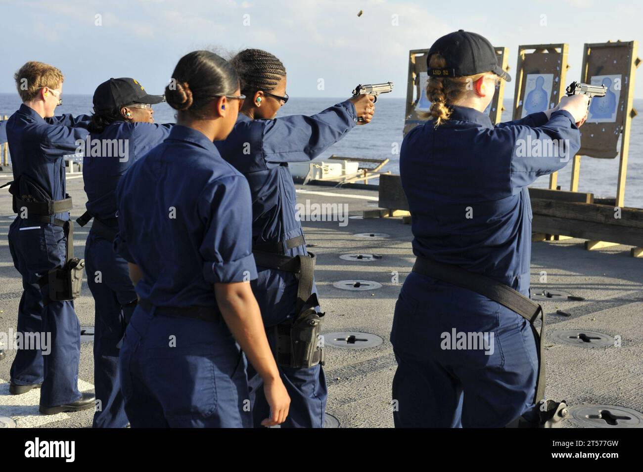 US Navy Sailors aboard the amphibious dock landing ship USS Pearl ...