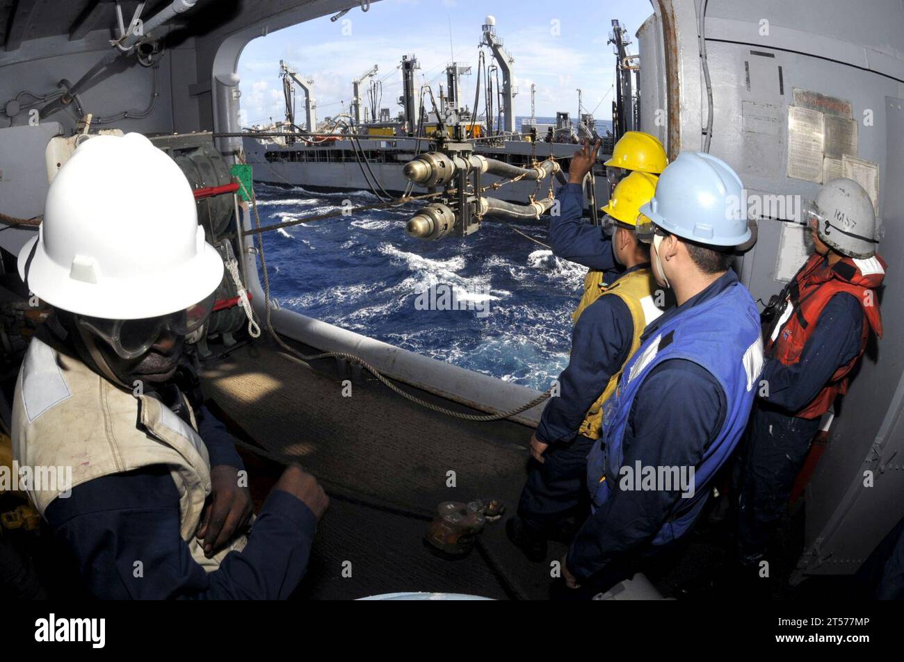 US Navy Sailors aboard the forward-deployed amphibious assault ship USS ...