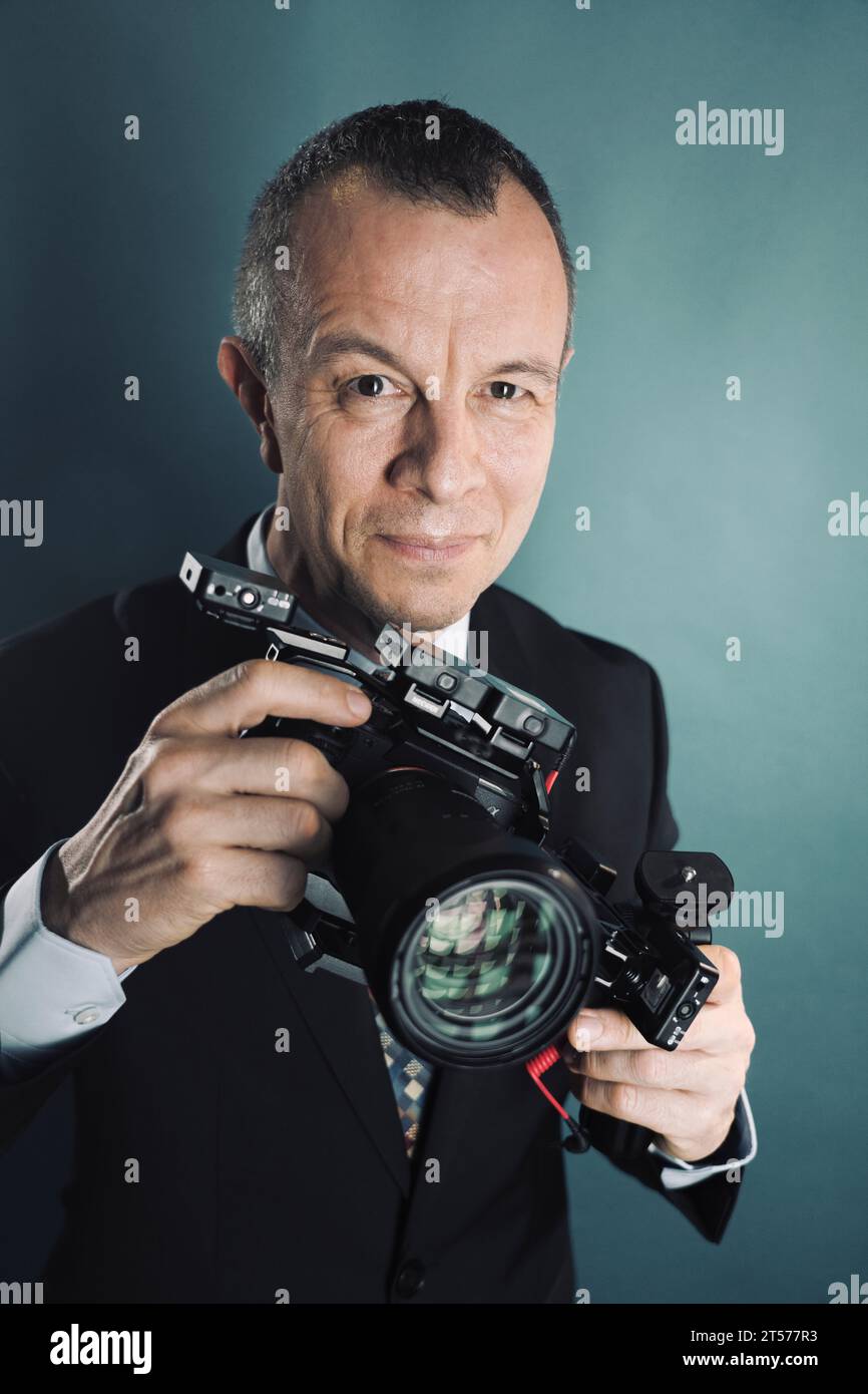 Photographer videographer in studio in suit photo Stock Photo - Alamy