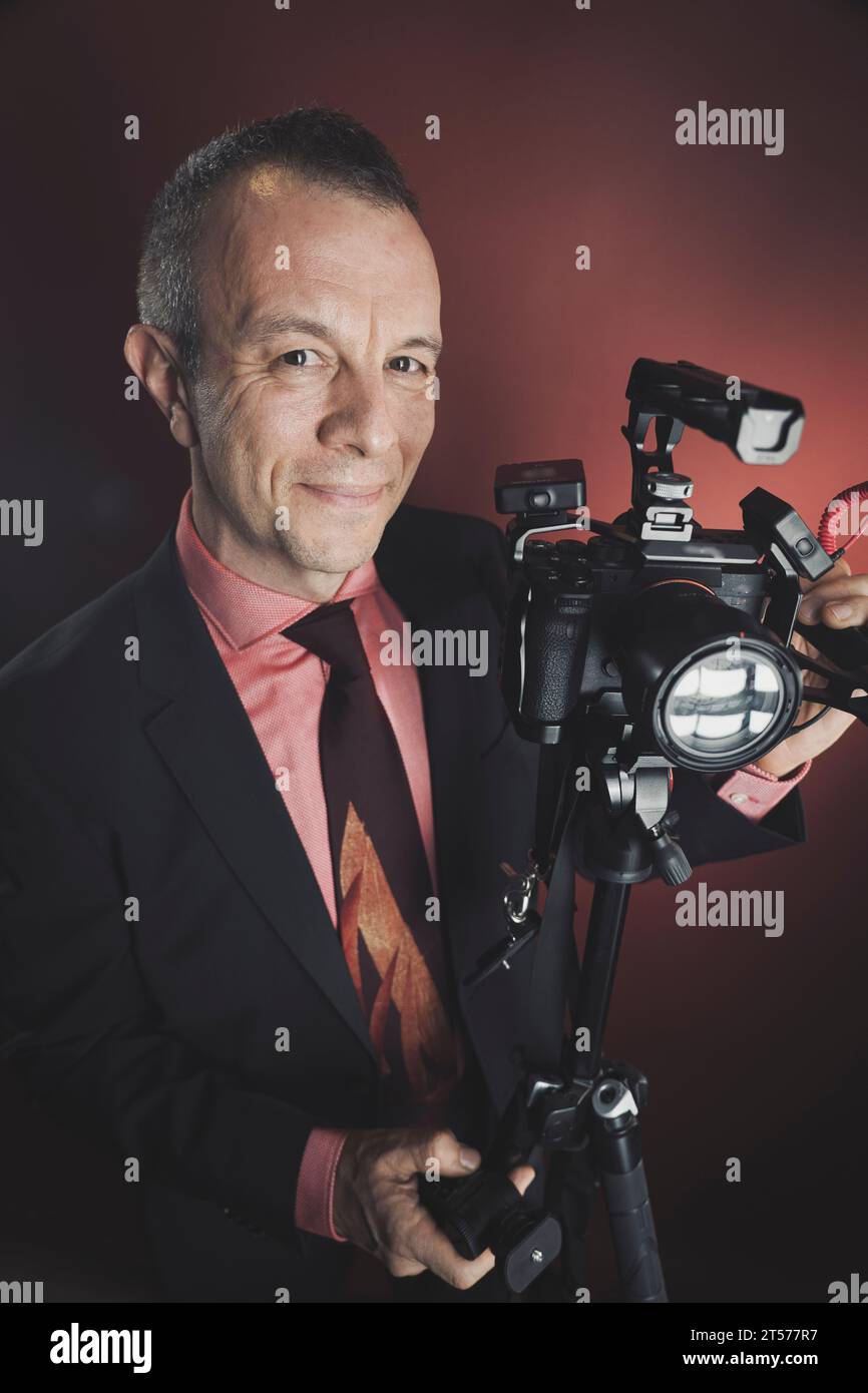 Photographer videographer in studio in suit photo Stock Photo - Alamy