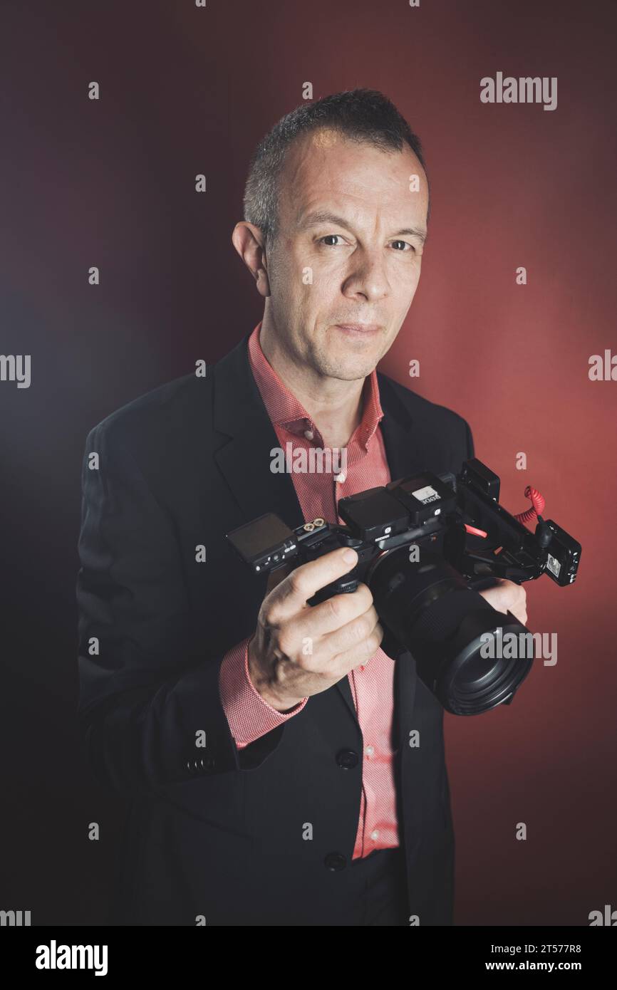 Photographer videographer in studio in suit photo Stock Photo - Alamy