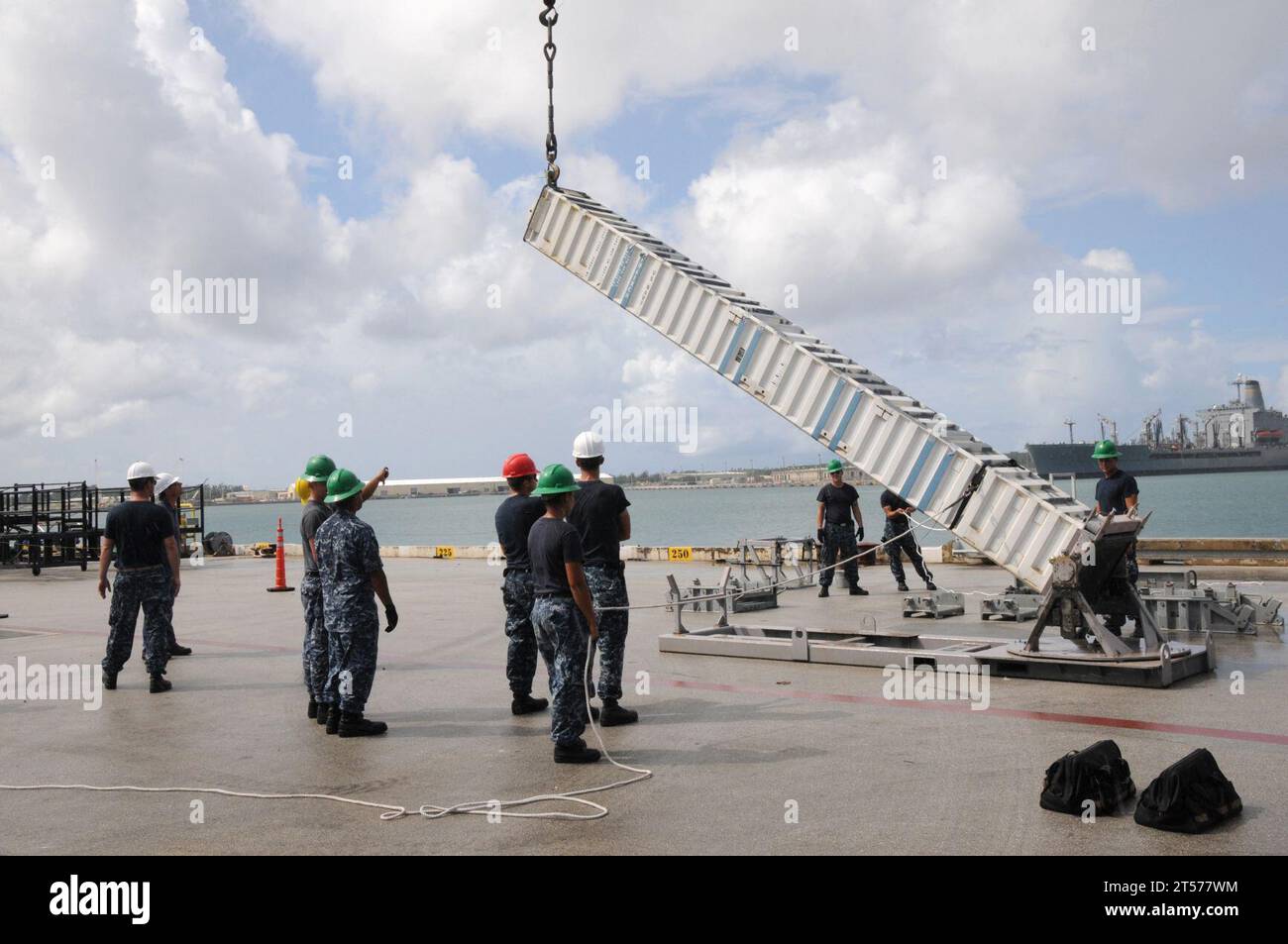 US Navy Sailors aboard the submarine tender USS Frank Cable prepare to ...