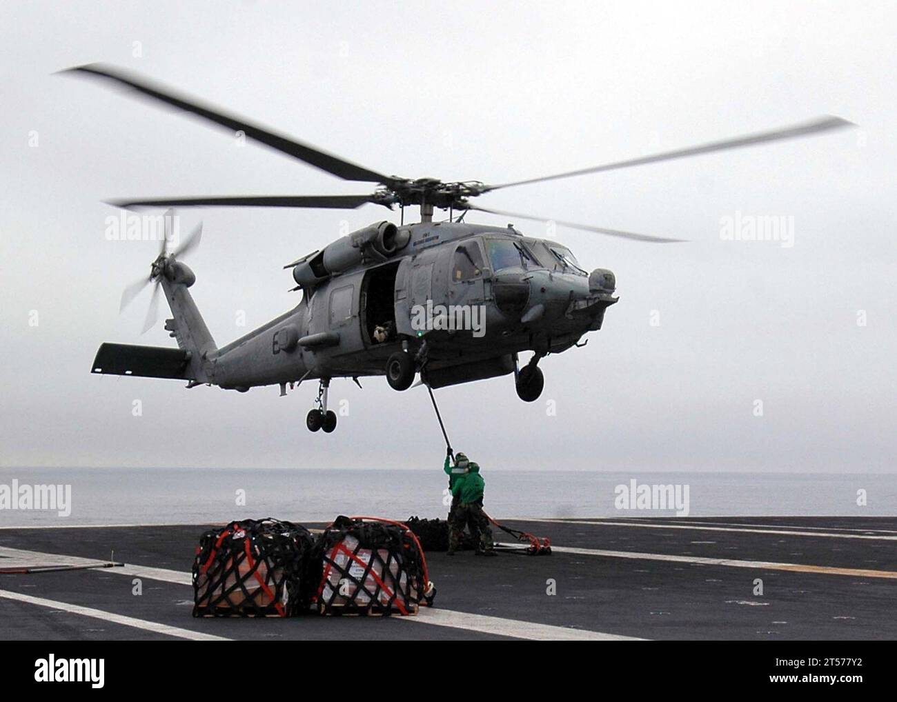US Navy Sailors aboard USS George Washington (CVN 73) attach a cargo ...