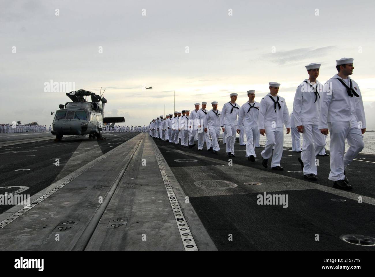 US Navy Sailors aboard USS George Washington (CVN 73) man the rails as ...