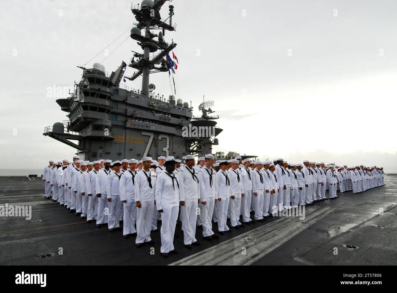 US Navy Sailors aboard USS George Washington (CVN 73) stand ready to man the rails as the ship ...