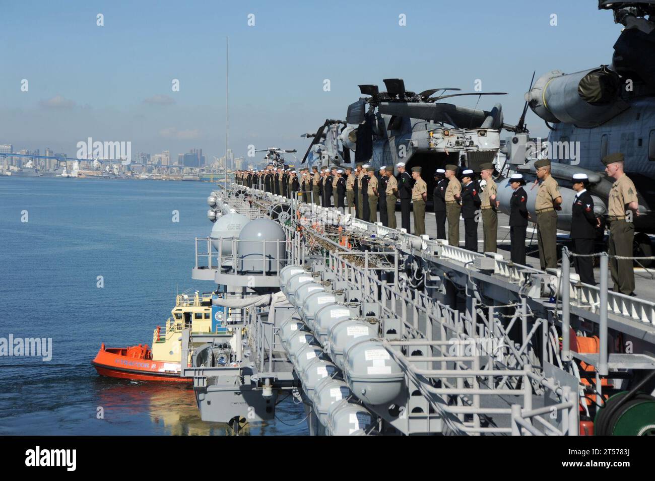 US Navy Sailors and Marines man the rails aboard the amphibious assault ...