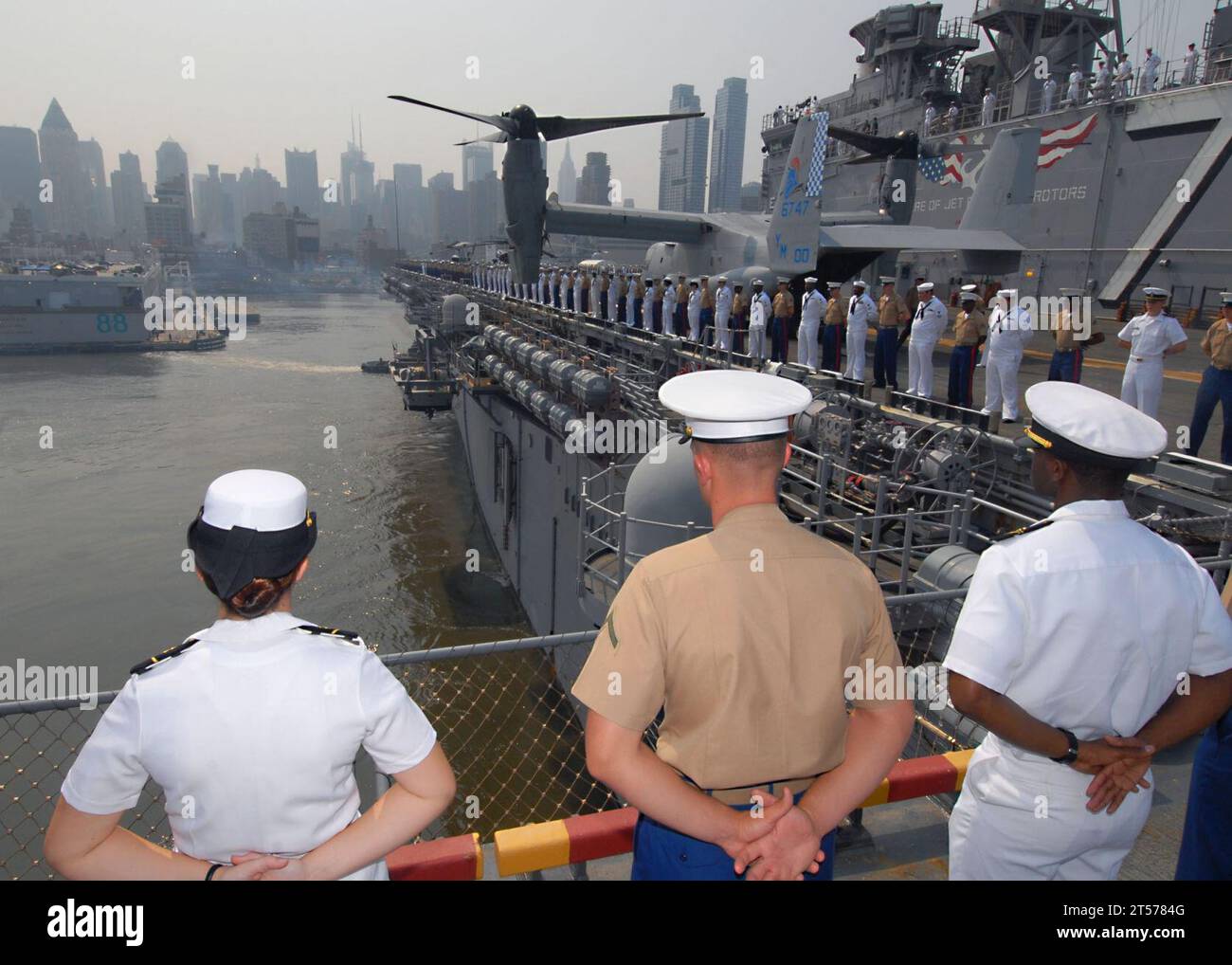 US Navy Sailors and Marines man the rails as the multipurpose ...