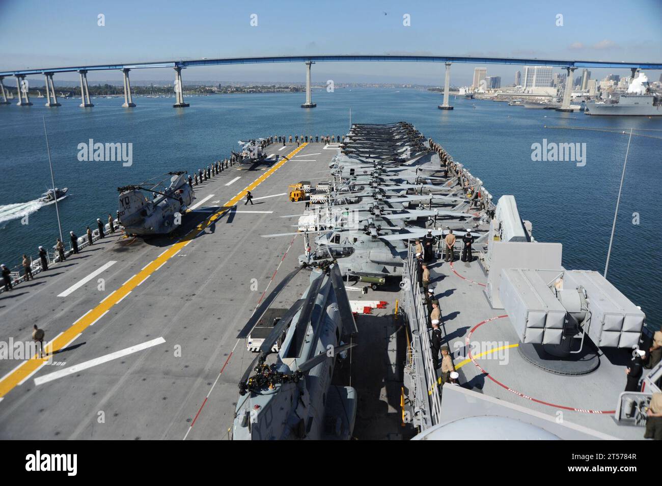 US Navy Sailors and Marines man the rails aboard the amphibious assault ...