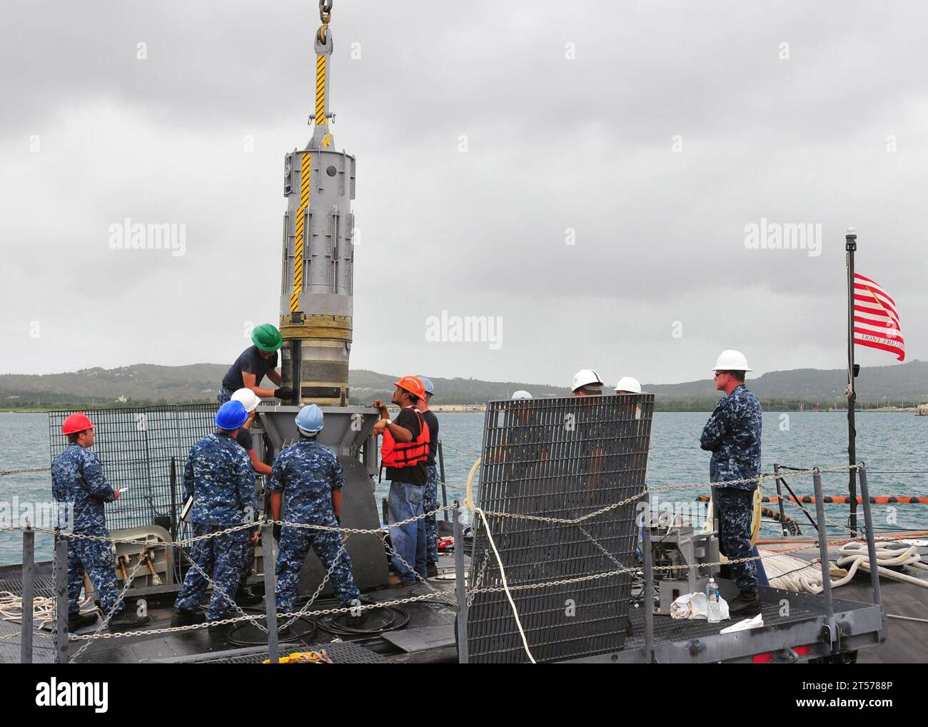 US Navy Sailors assigned to both the submarine tender USS Emory S. Land ...