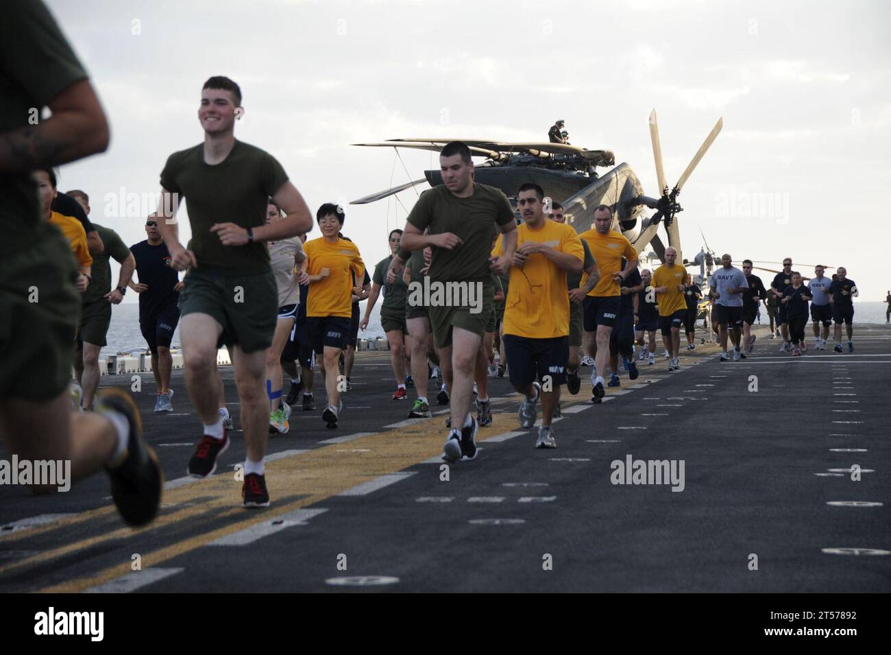 US Navy Sailors and Marines participate in a steel beach 5-kilometer-10 ...