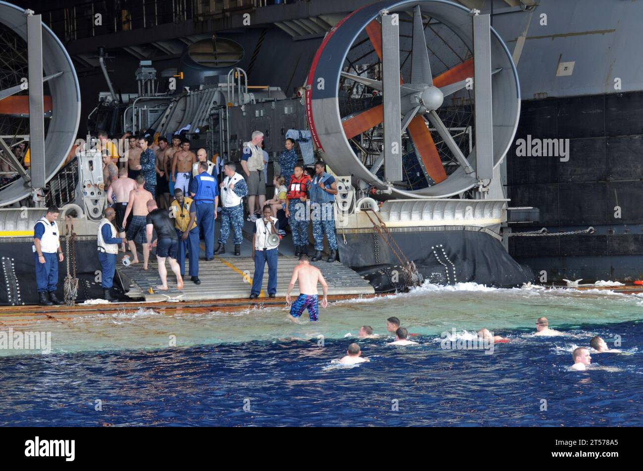 US Navy Sailors and Marines participate in a swim call from the multi ...