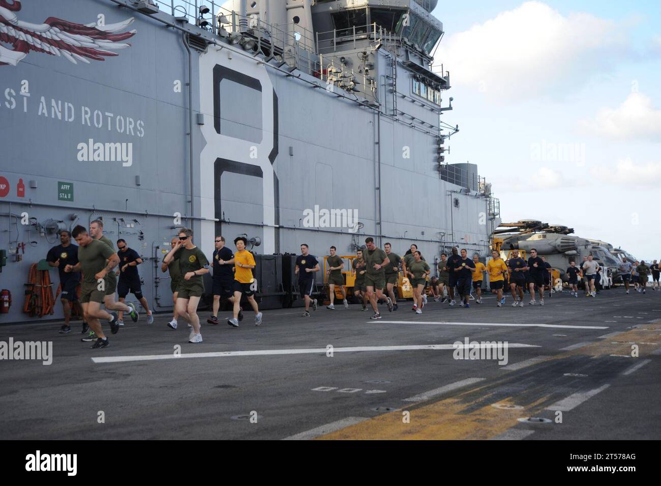 US Navy Sailors and Marines participate in a steel beach 5-kilometer-10 ...