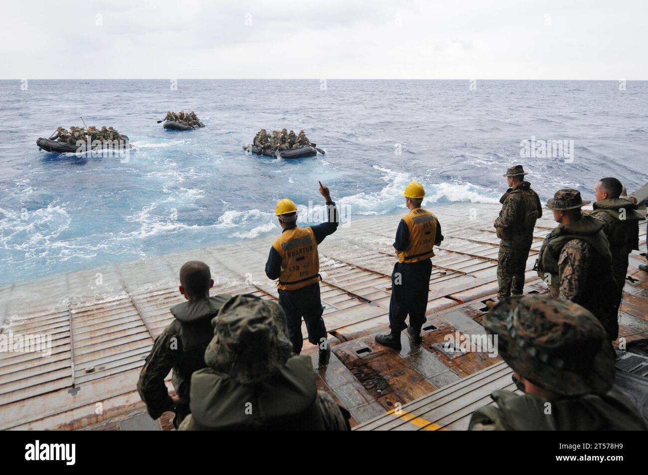 US Navy Sailors assigned to the forward-deployed amphibious dock ...