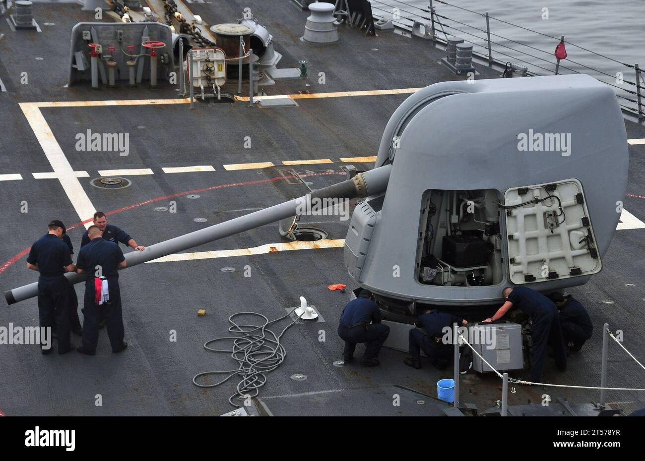 US Navy Sailors clean the MK-45 5-inch.54-caliber lightweight gun ...