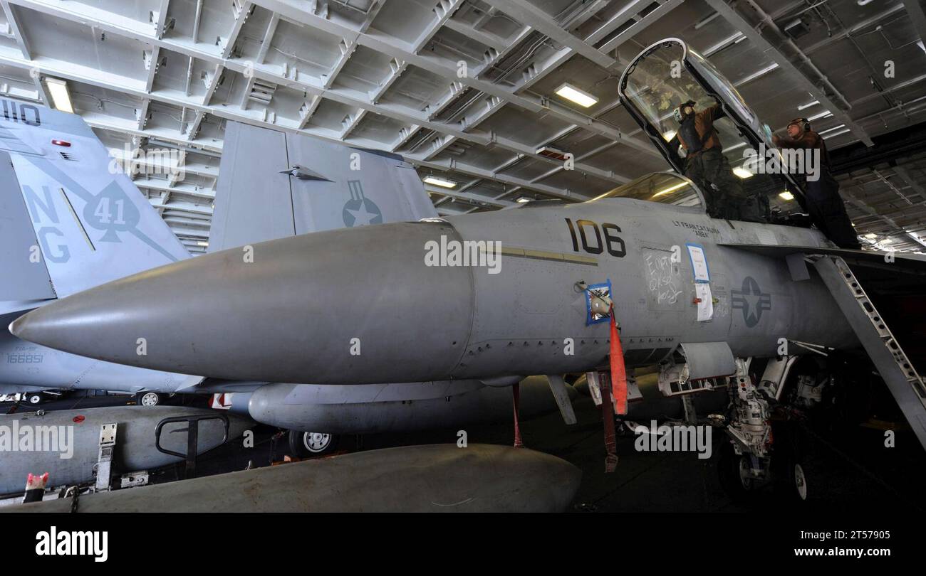 US Navy Sailors clean the canopy on an F18F Super Hornet assigned to ...