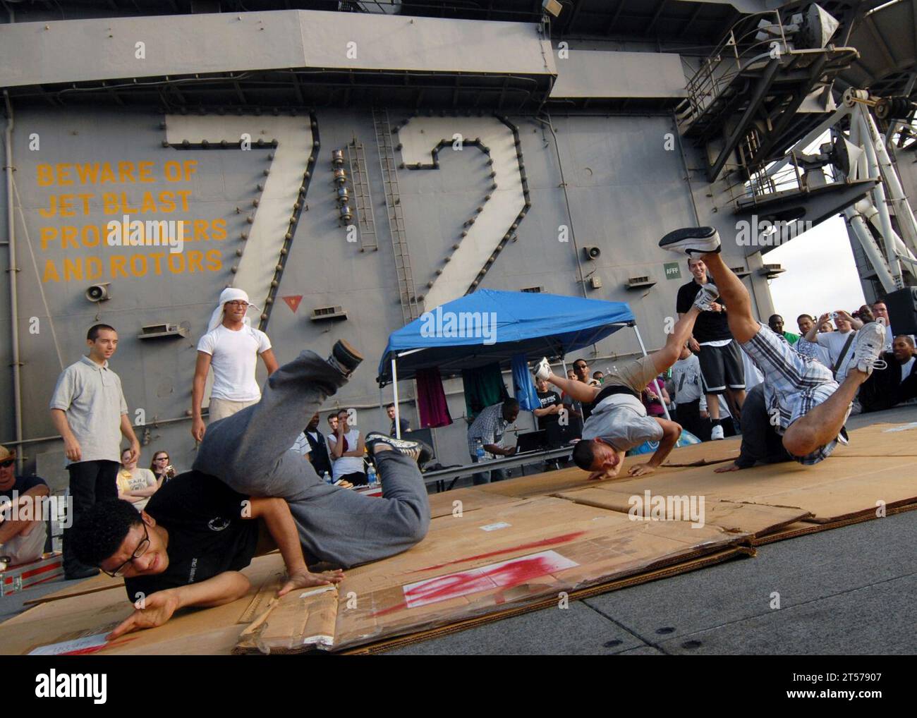 US Navy Sailors break dance on the flight deck during a steel beach ...