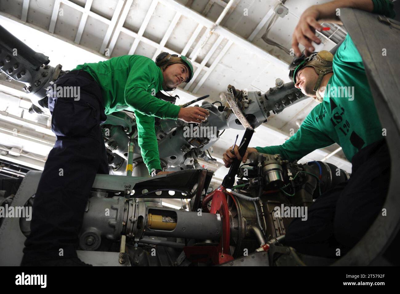 US Navy Sailors conduct routine maintenance on an SH-60F Seahawk aboard ...