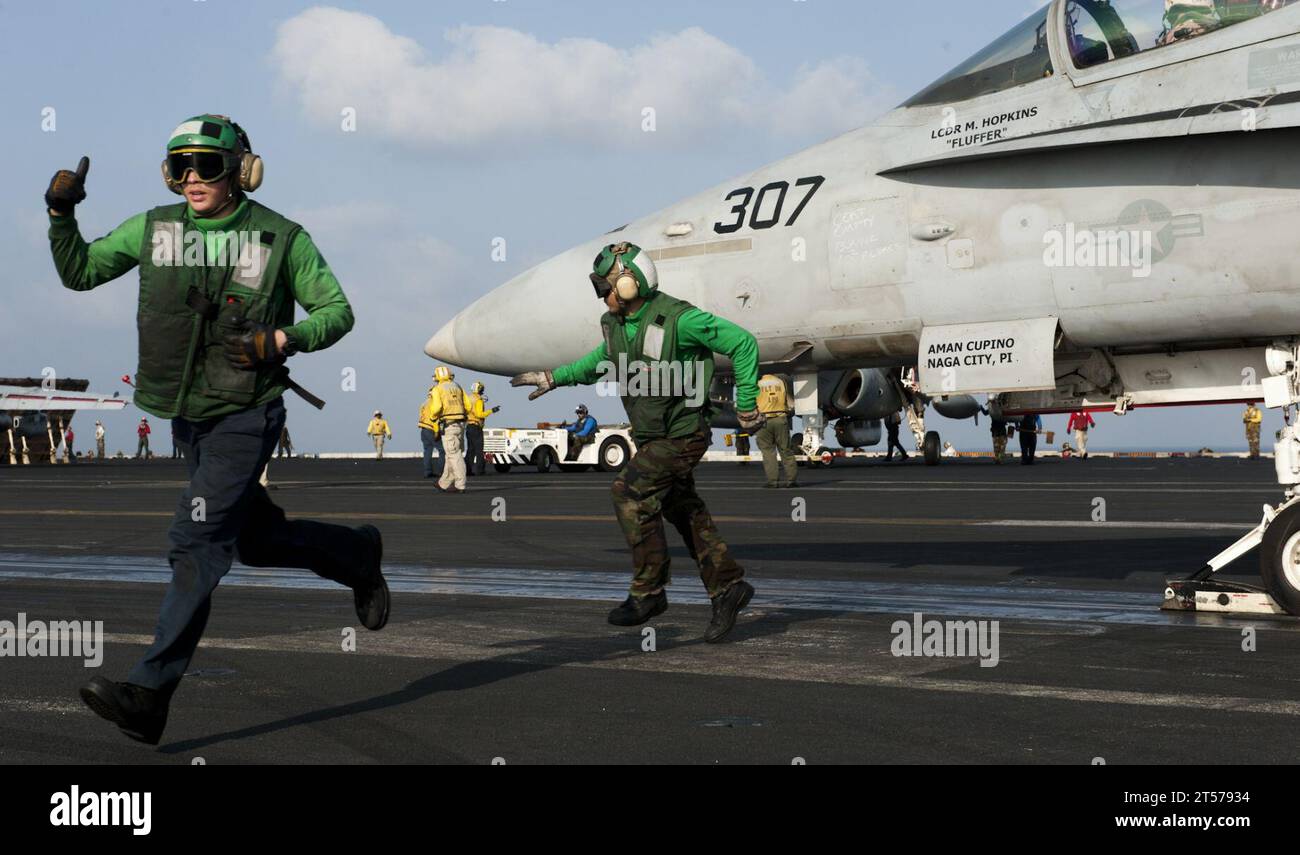 US Navy Sailors clear the launching area as an F18C Hornet prepares to ...