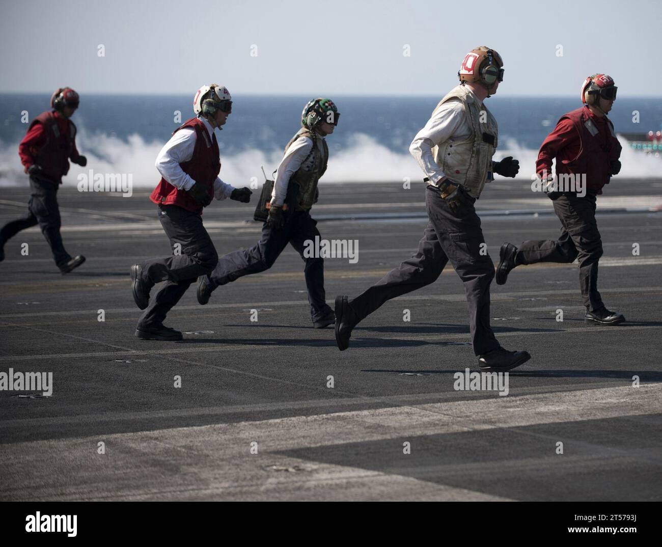 US Navy Sailors clear the landing area after launching the last ...