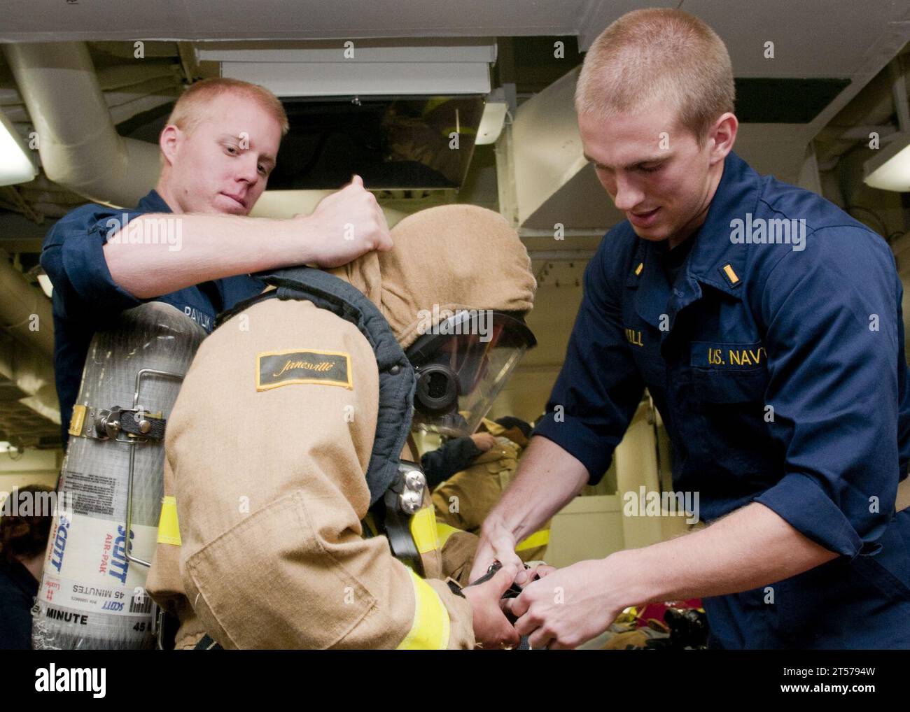 US Navy Sailors dress out in a full firefighting ensemble as part of ...