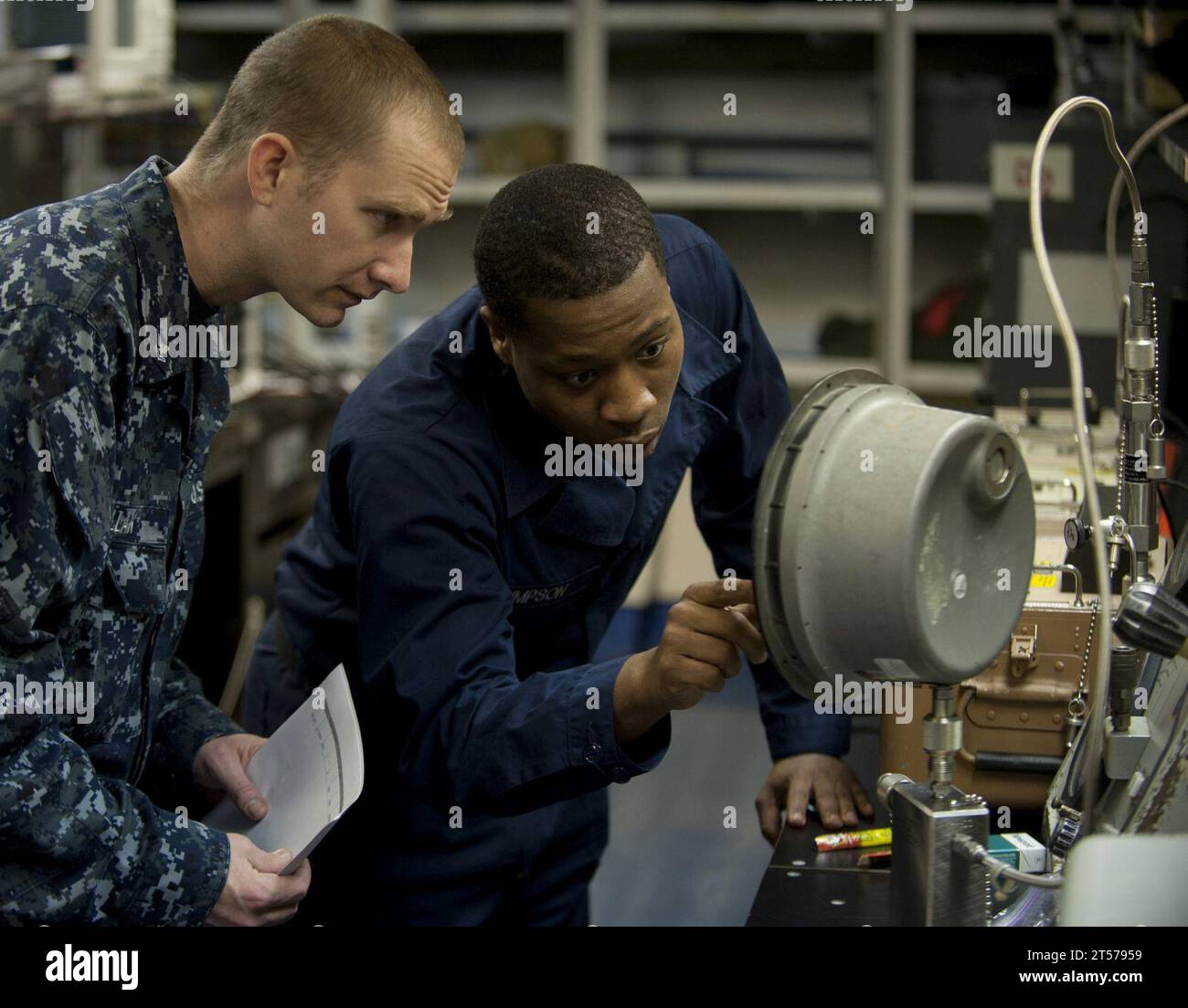 US Navy Sailors discusses the calibration of a pressure gauge.jpg Stock ...