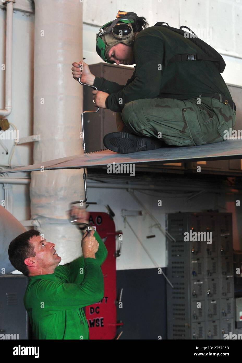 US Navy Sailors fasten rivets into the wing of an EA-6B Prowler.jpg ...