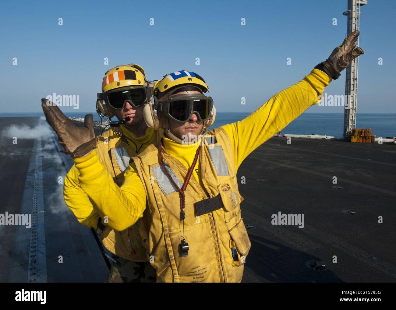 US Navy Sailors direct aircraft on the flight deck of the aircraft ...