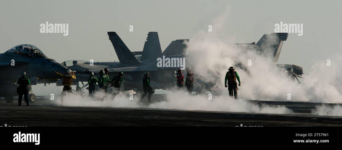 US Navy Sailors directs aircraft into position during flight operations ...