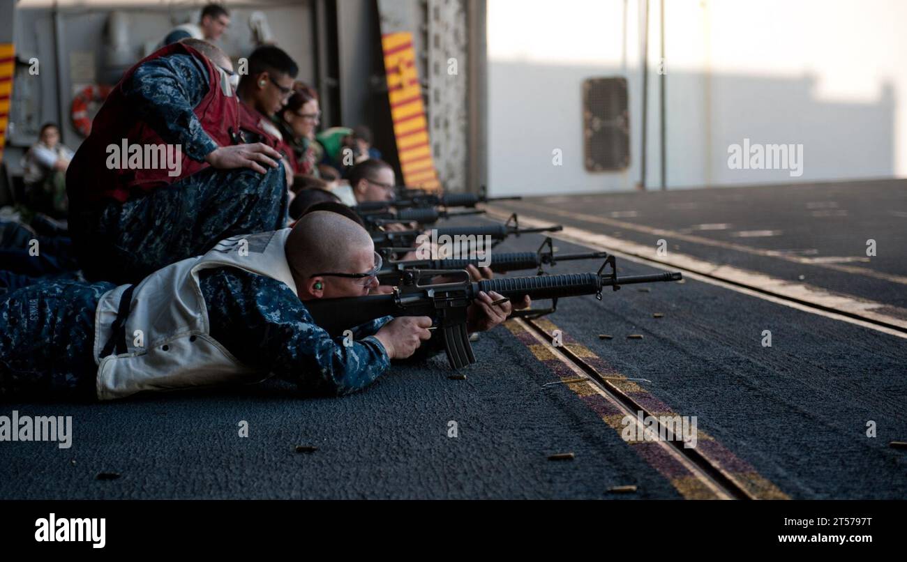 US Navy Sailors fire M-16 rifles during a small arms gun qualification ...