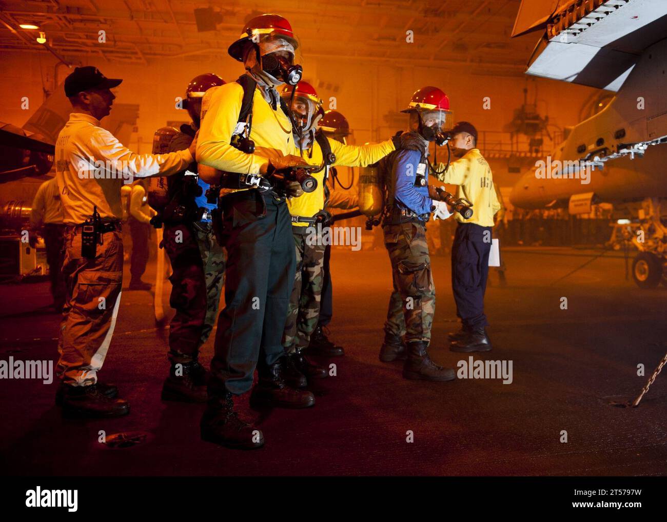US Navy Sailors fight a simulated fire during a general quarters ...