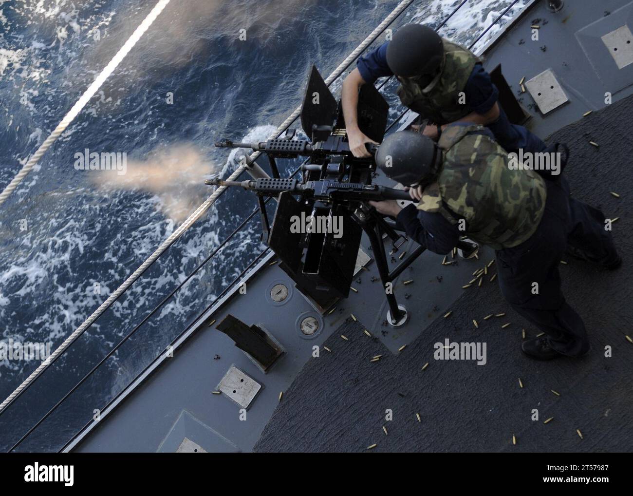 US Navy Sailors fire a dual-mounted M-240 machine gun during a live ...