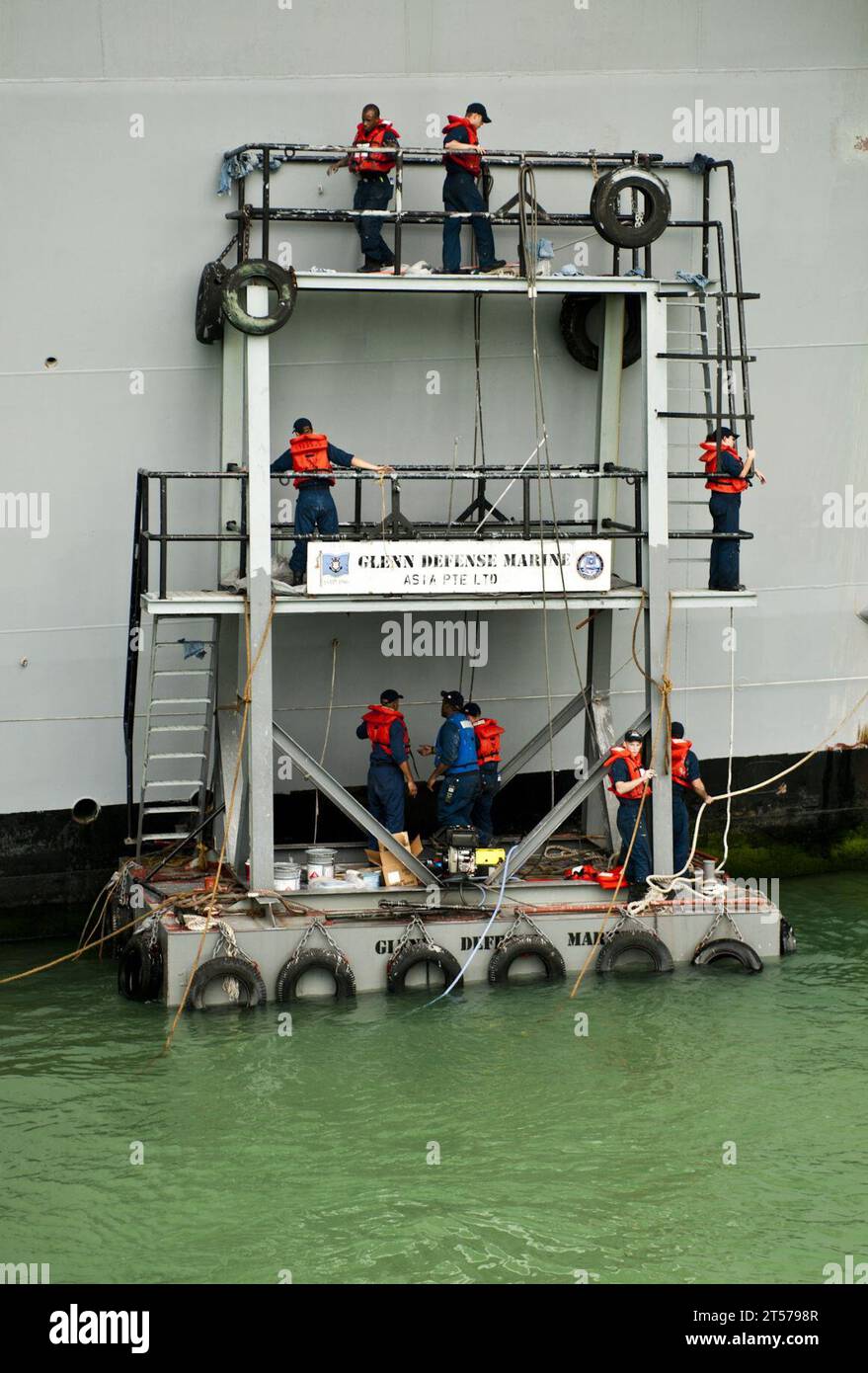US Navy Sailors from Deck Department paint the side of the Nimitz-class ...