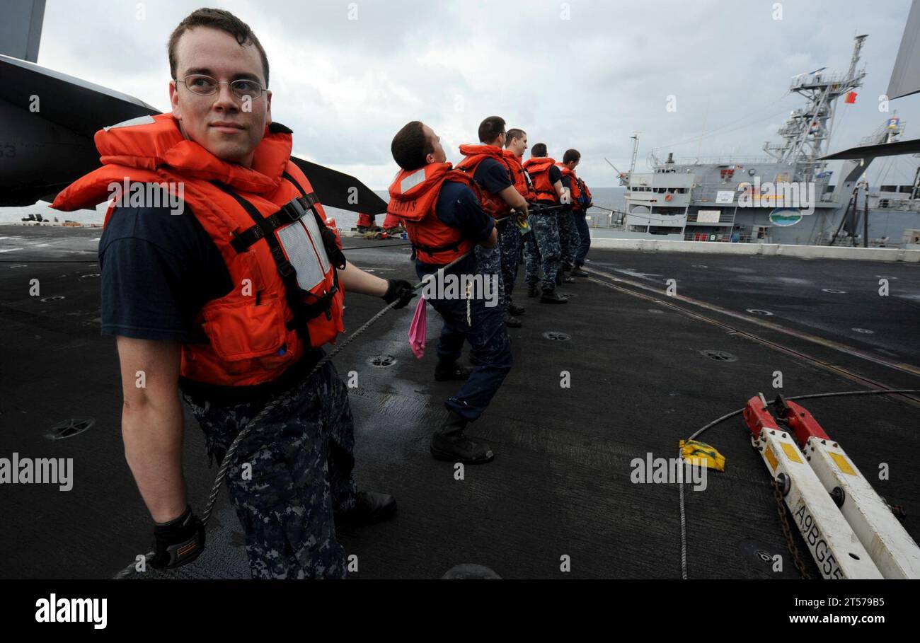 US Navy Sailors heave the phone and distance line on the flight deck of ...