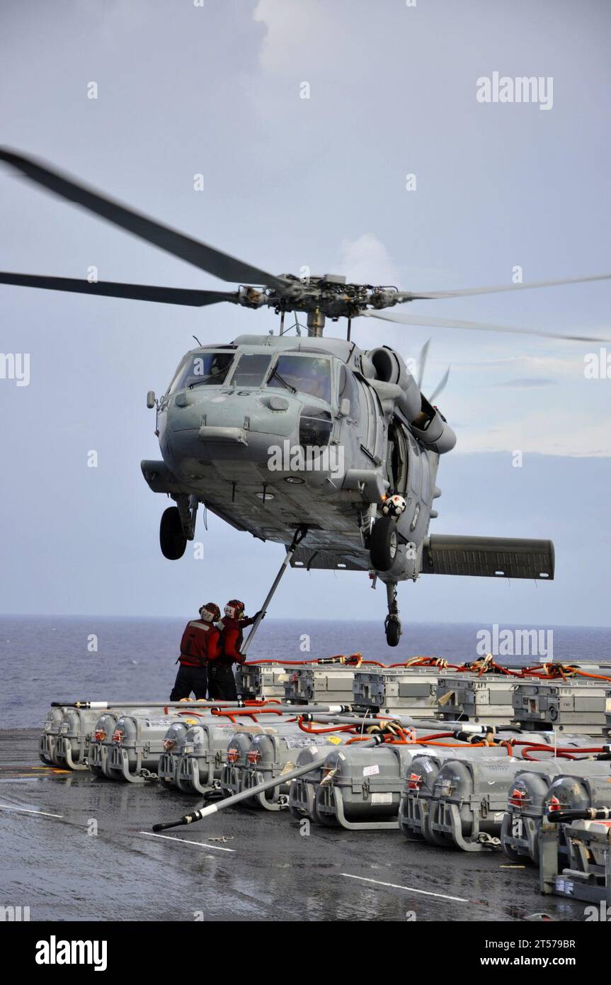 US Navy Sailors hook an ammunition pallet to an MH-60S Sea Hawk ...