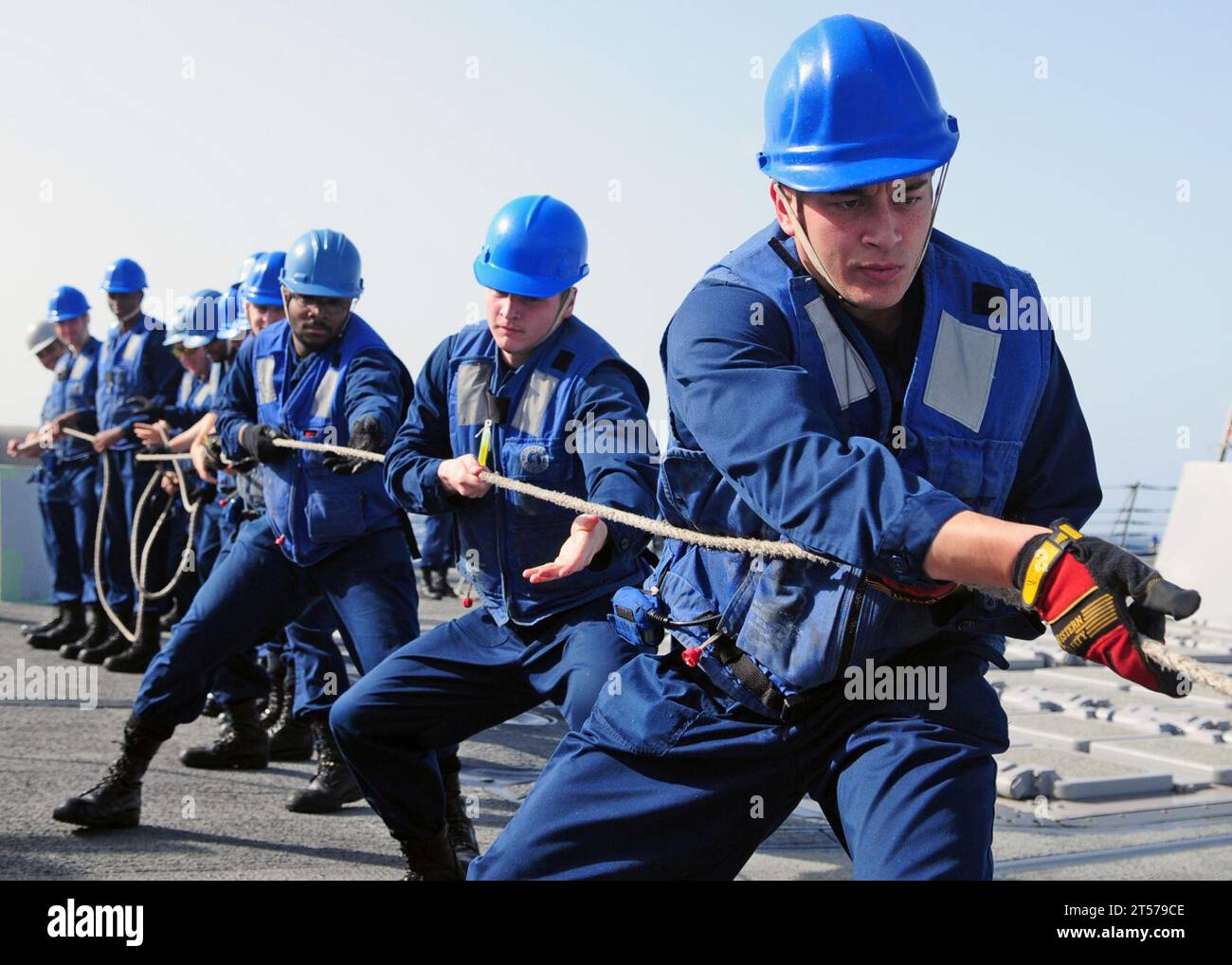 US Navy Sailors heave a fuel line aboard the guided-missile destroyer ...