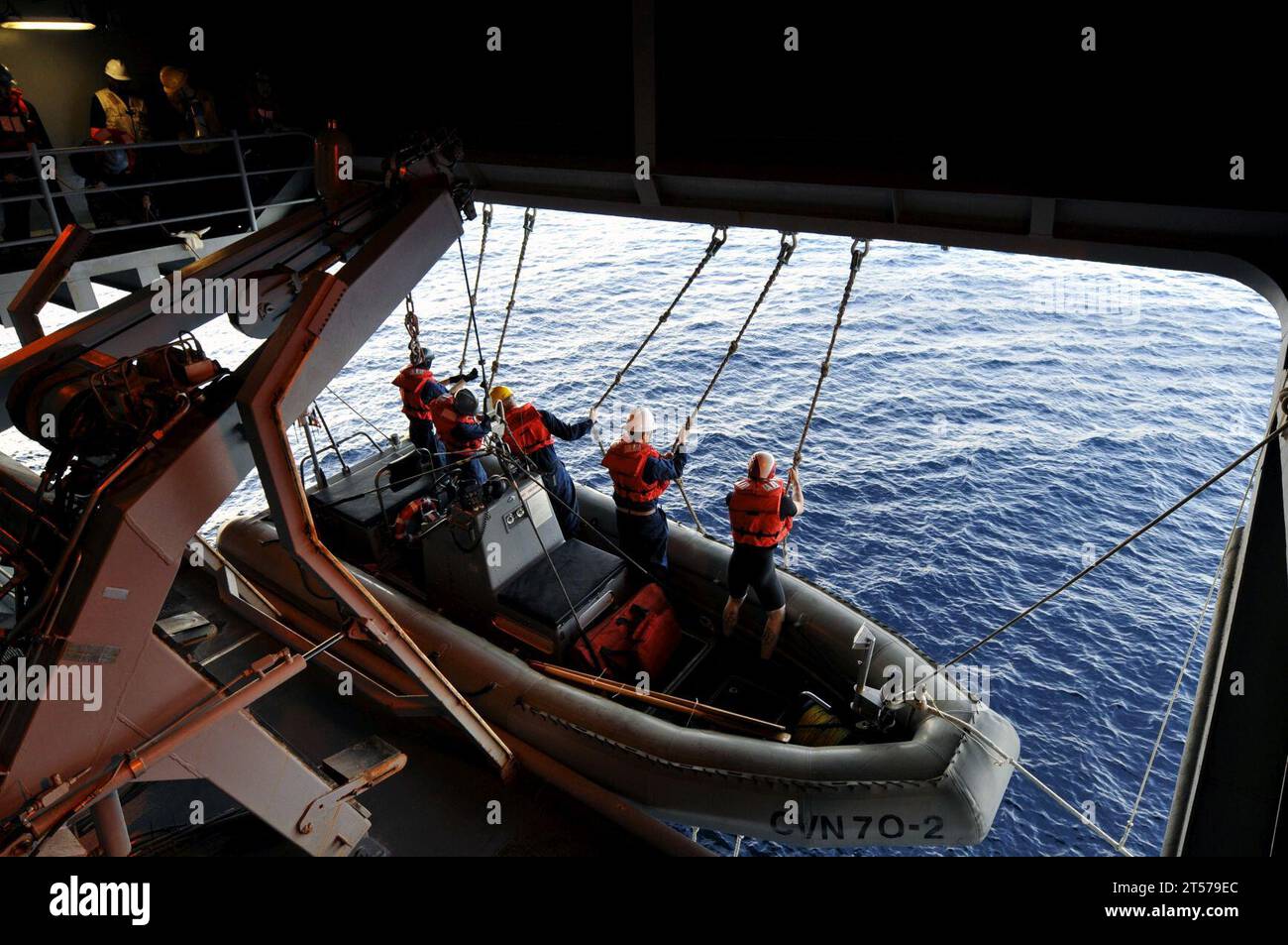 US Navy Sailors launch a rigid-hull inflatable boat during a man ...