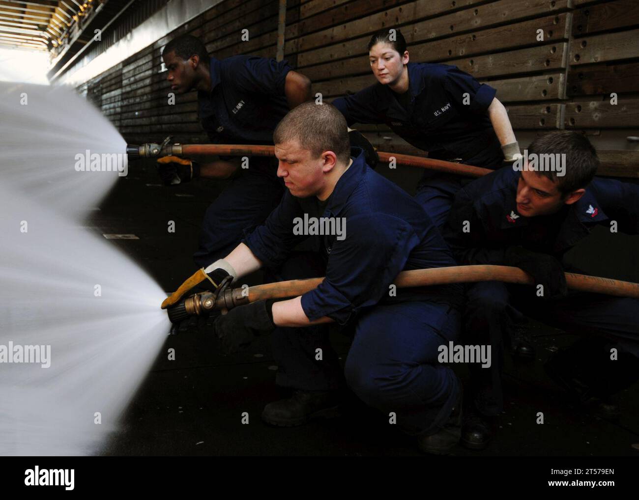 US Navy Sailors man a fire hose during a crash and salvage drill.jpg ...