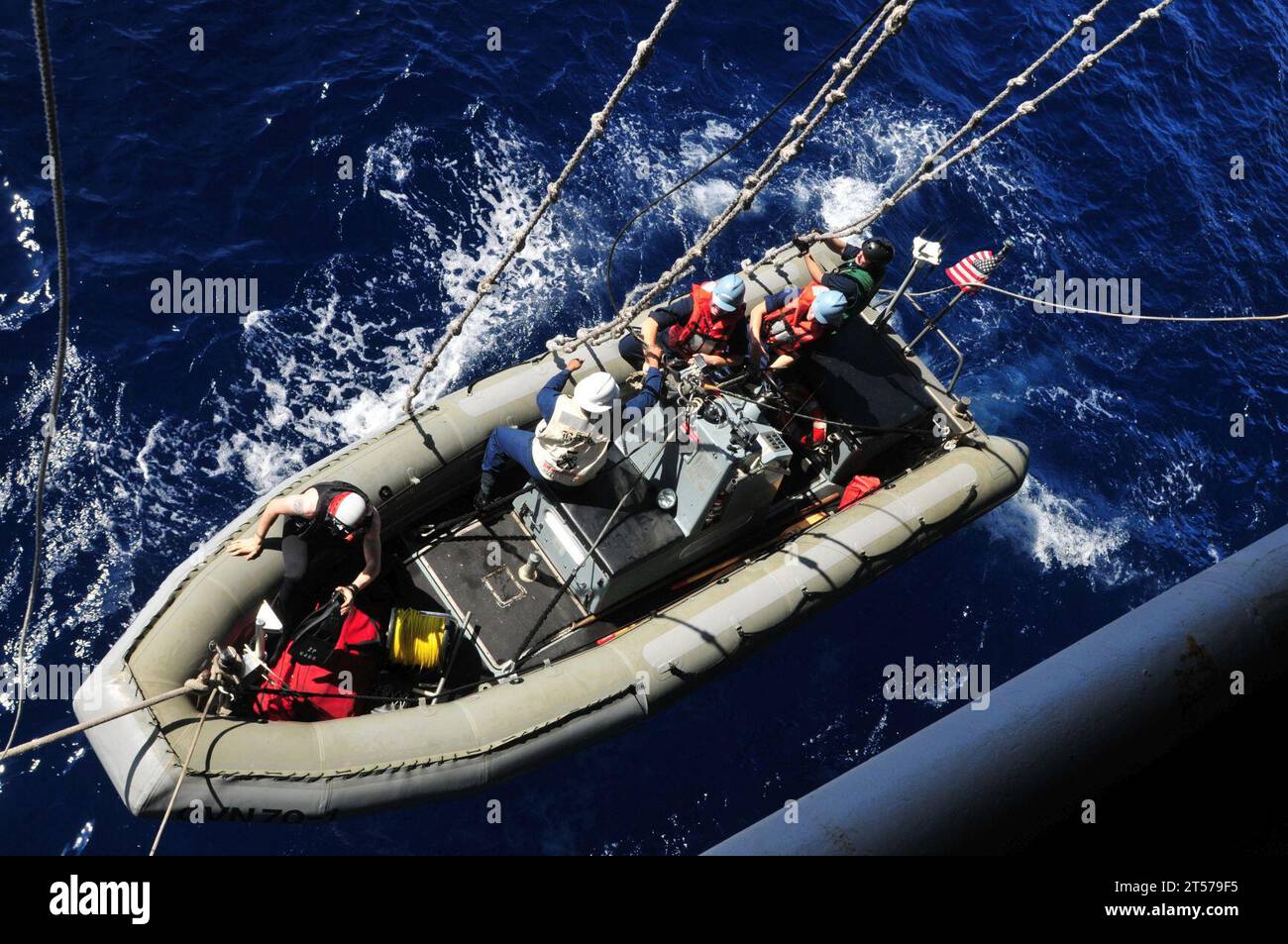 US Navy Sailors launch a rigid-hull inflatable boat during a man ...