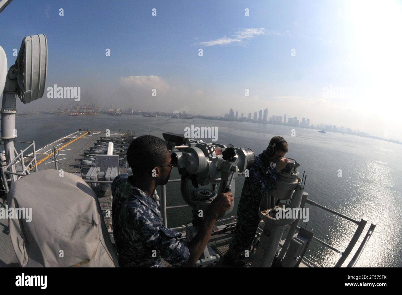 US Navy Sailors man the forward lookout watch on the signal bridge of ...