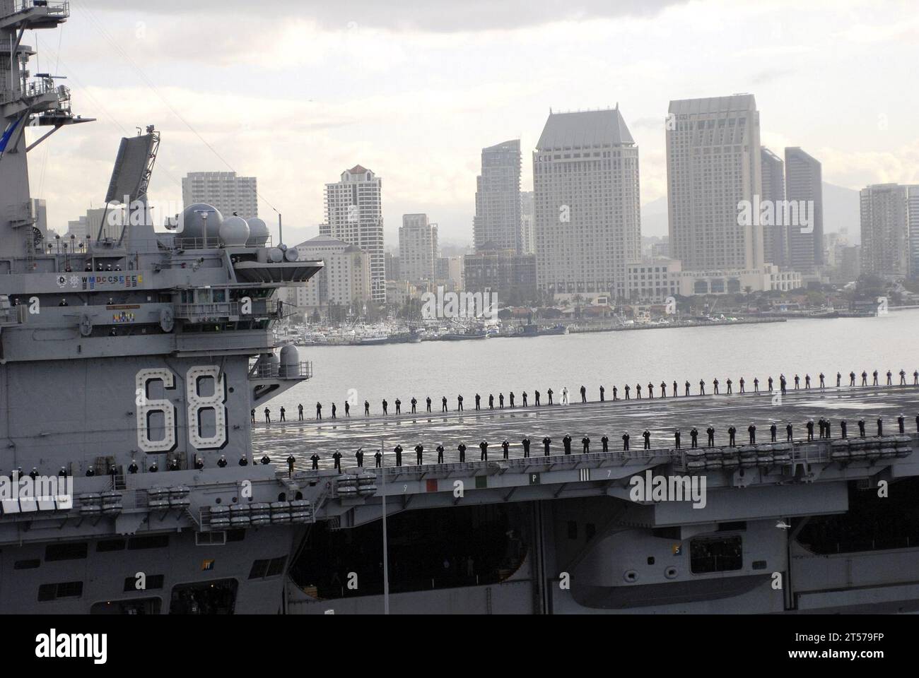 US Navy Sailors man the rails aboard the nuclear-powered aircraft ...