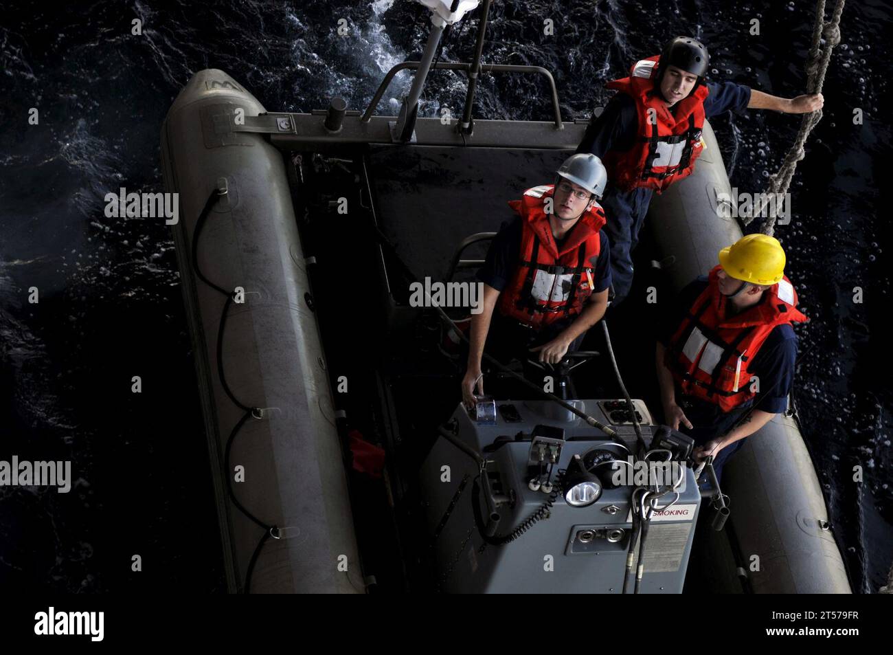 US Navy Sailors man a rigid hull inflatable boat during a man overboard ...