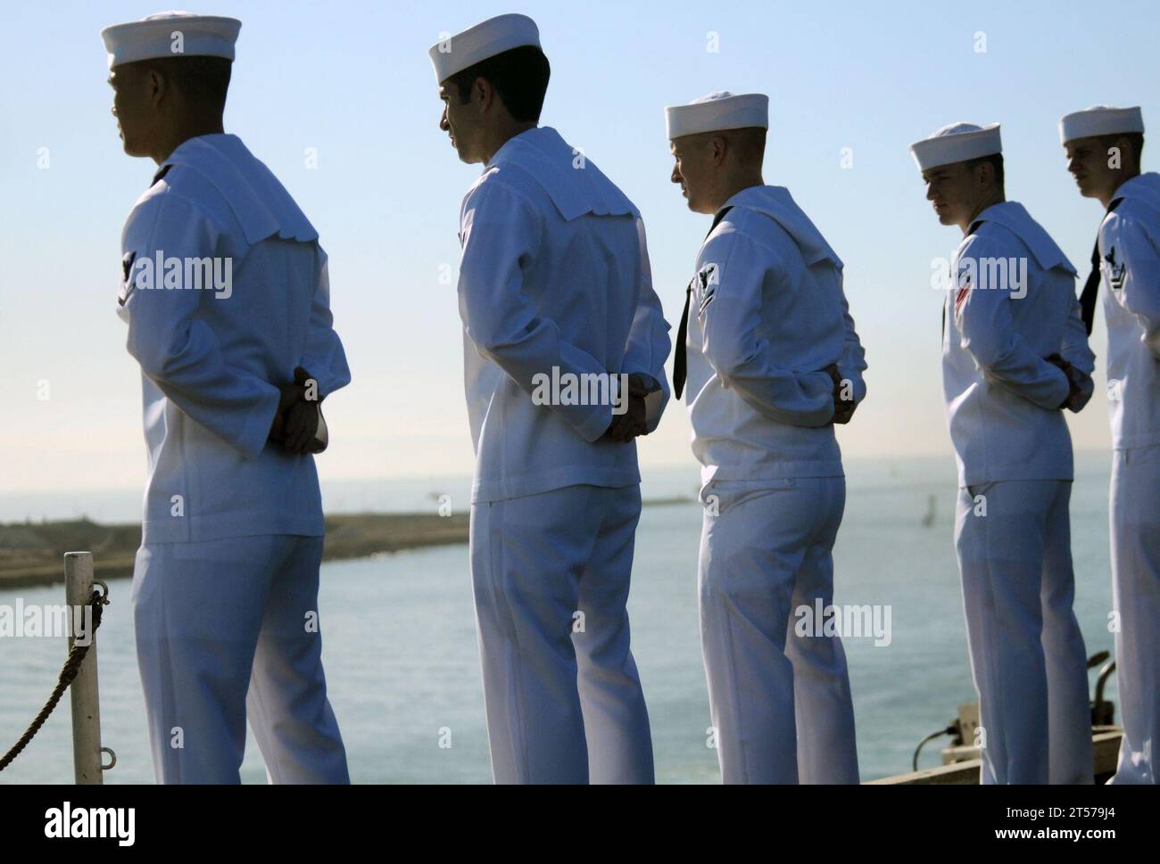 US Navy Sailors man the rails as the aircraft carrier USS Ronald Reagan ...