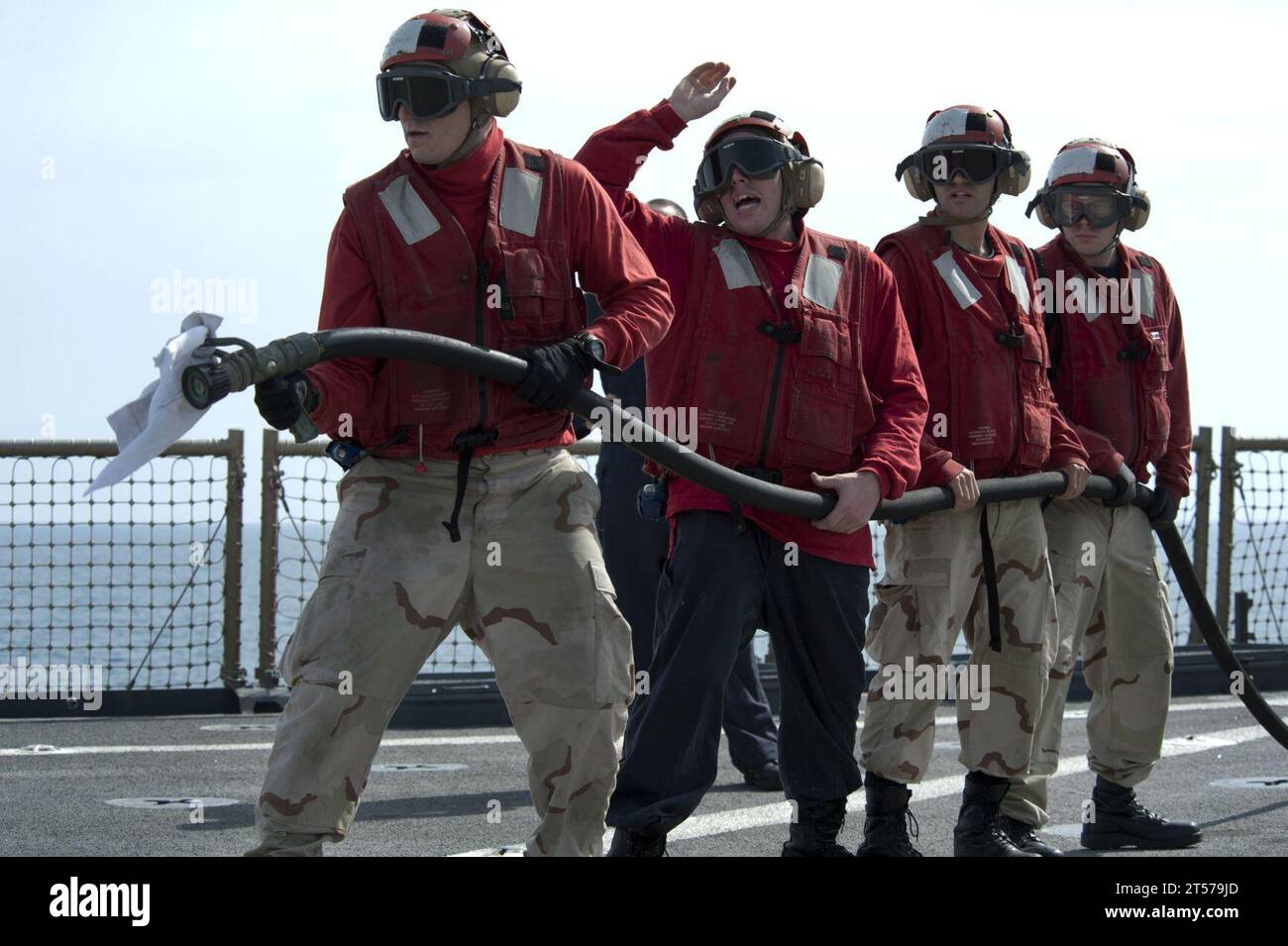 US Navy Sailors participate in a flight deck fire fighting drill aboard ...